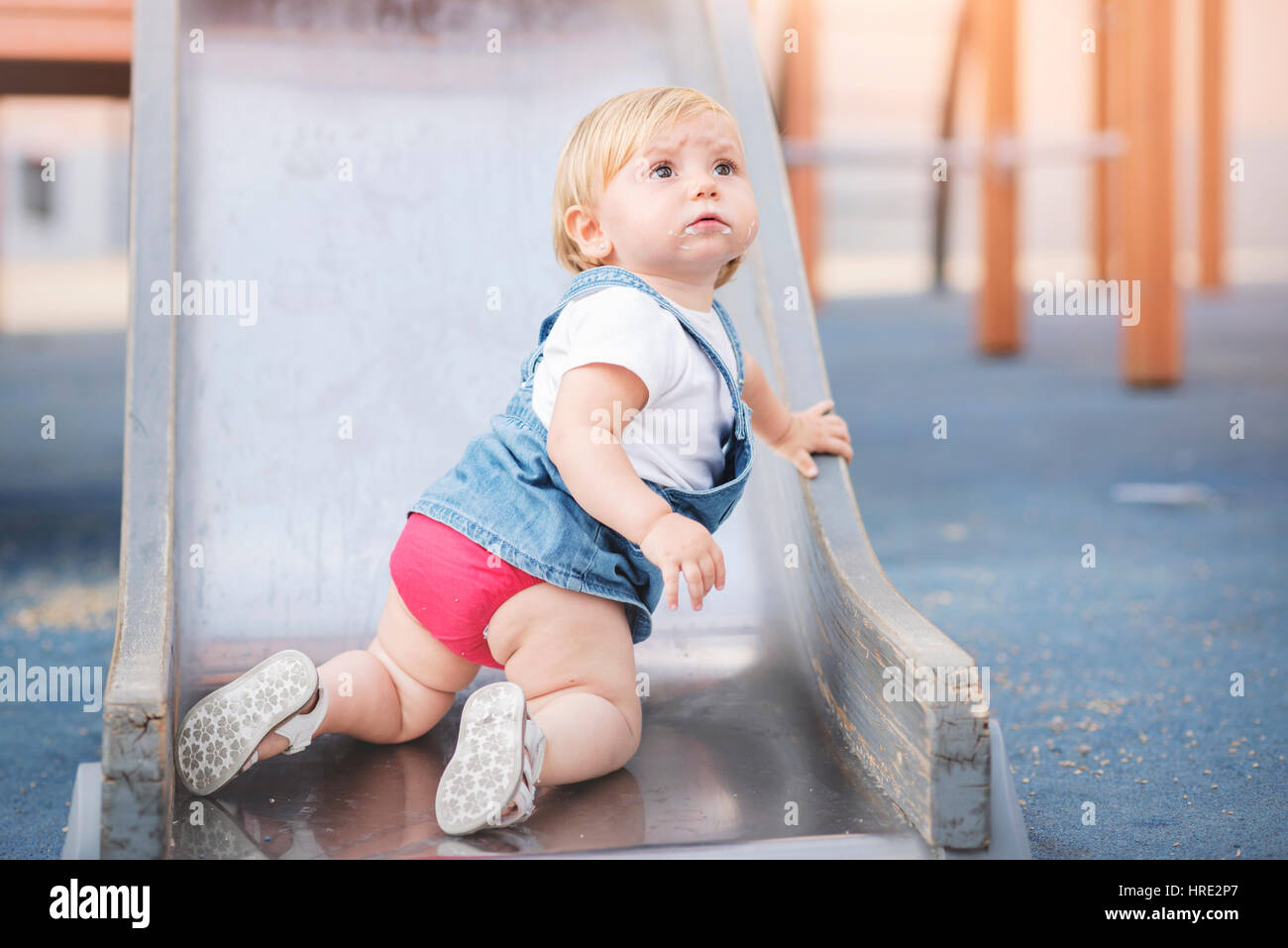 Baby in the playground Stock Photo - Alamy