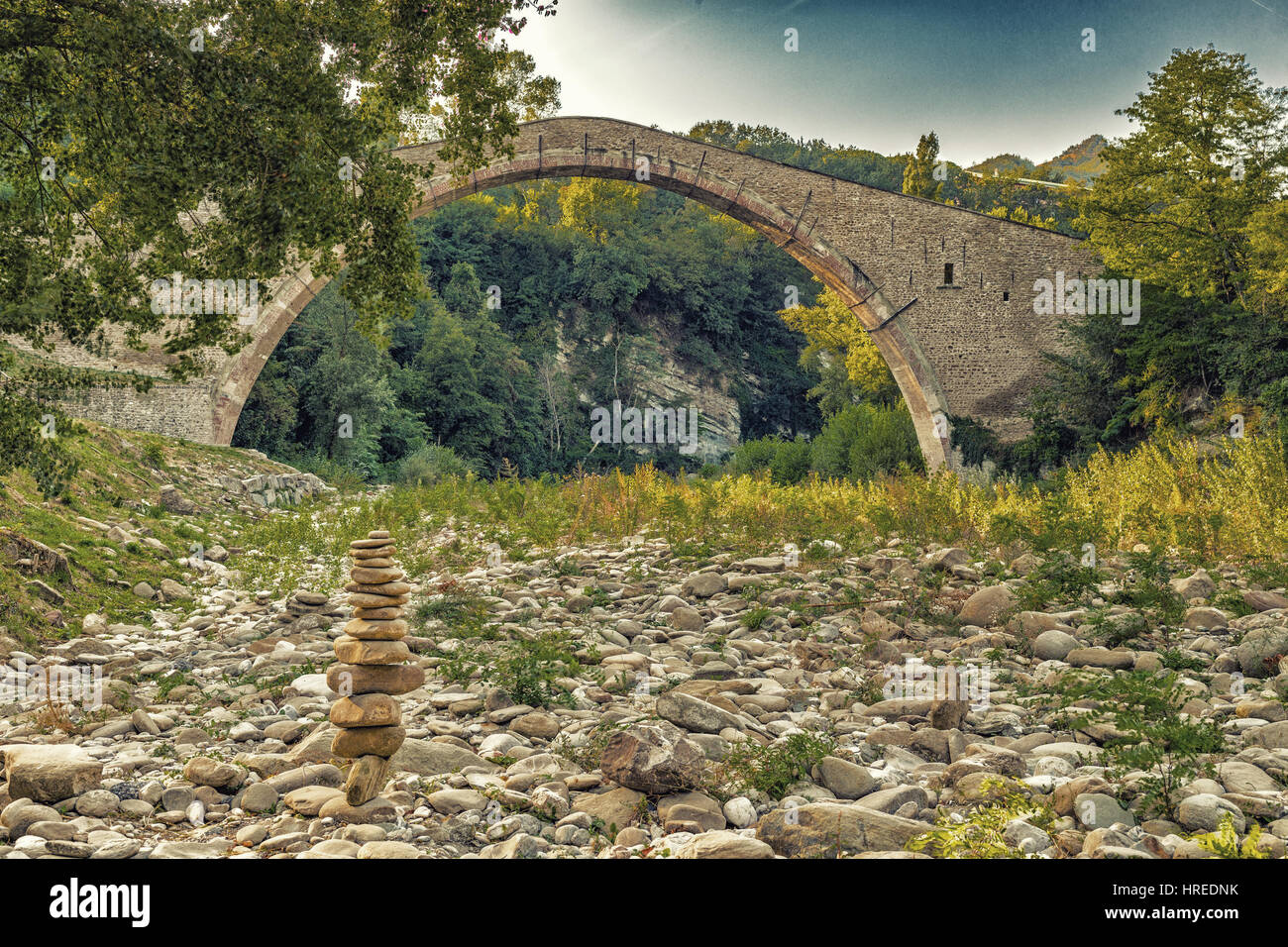 pile of stones in front of 500 years old hog backed Renaissance bridge ...