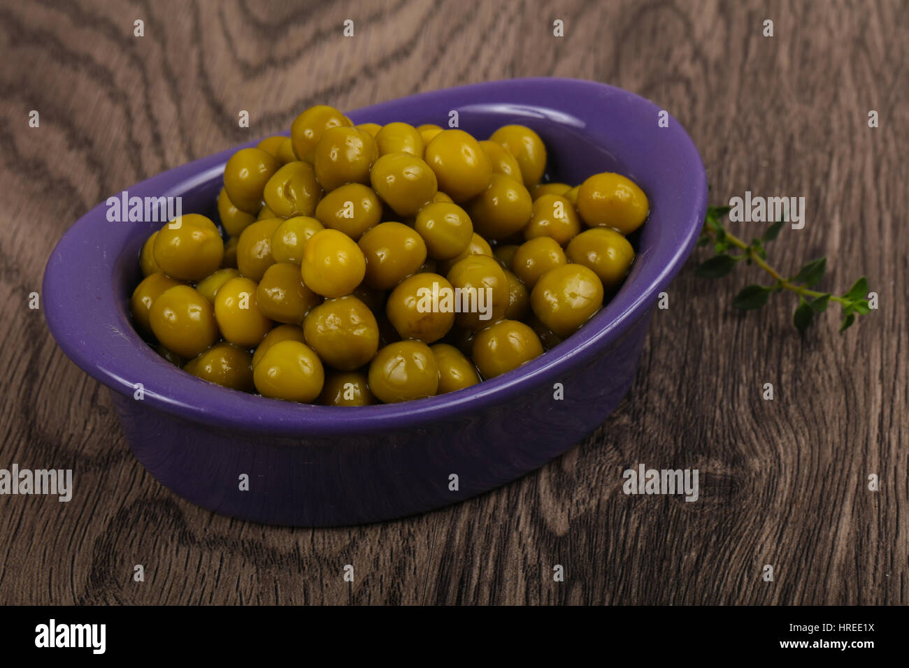 Pickled pea in the plate over wooden background Stock Photo - Alamy