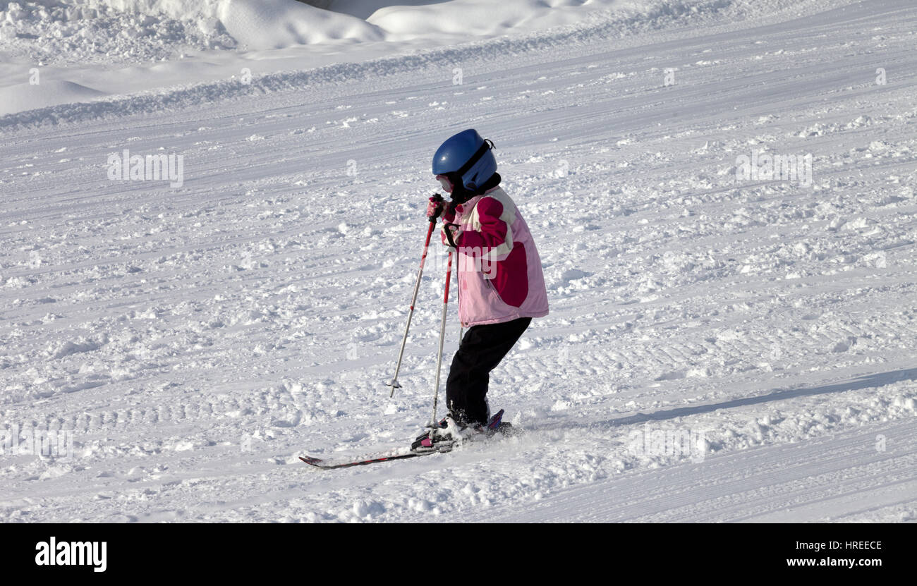 Little skier on ski slope at sun winter morning Stock Photo - Alamy