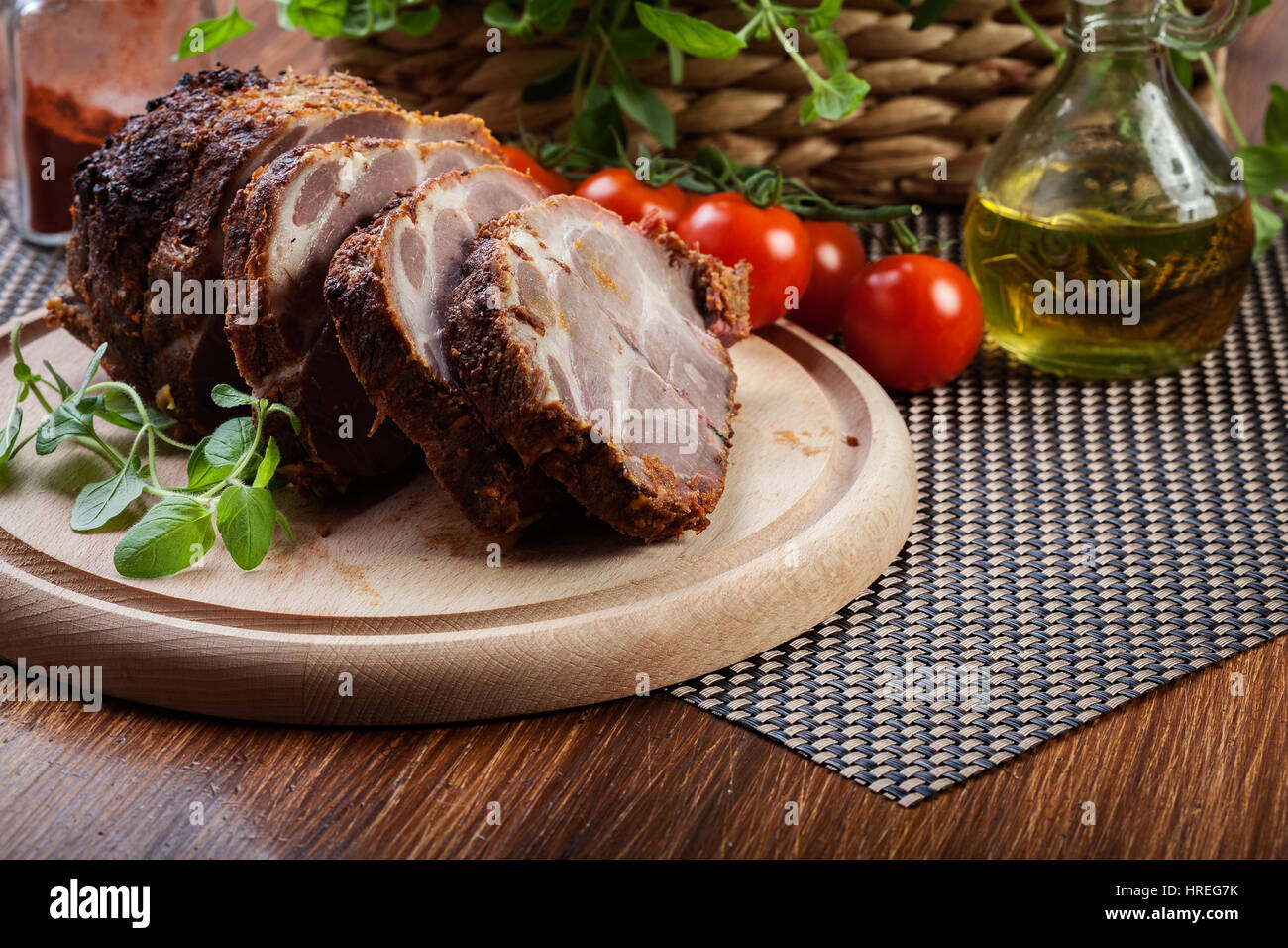 Roasted pork neck with spices on cutting board Stock Photo - Alamy