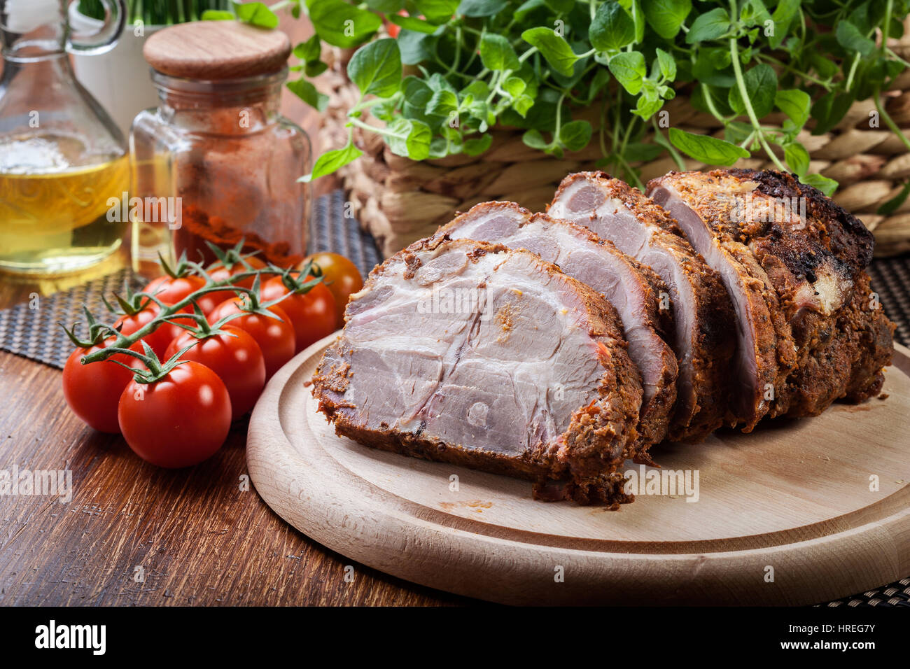 Roasted pork neck with spices on cutting board Stock Photo - Alamy