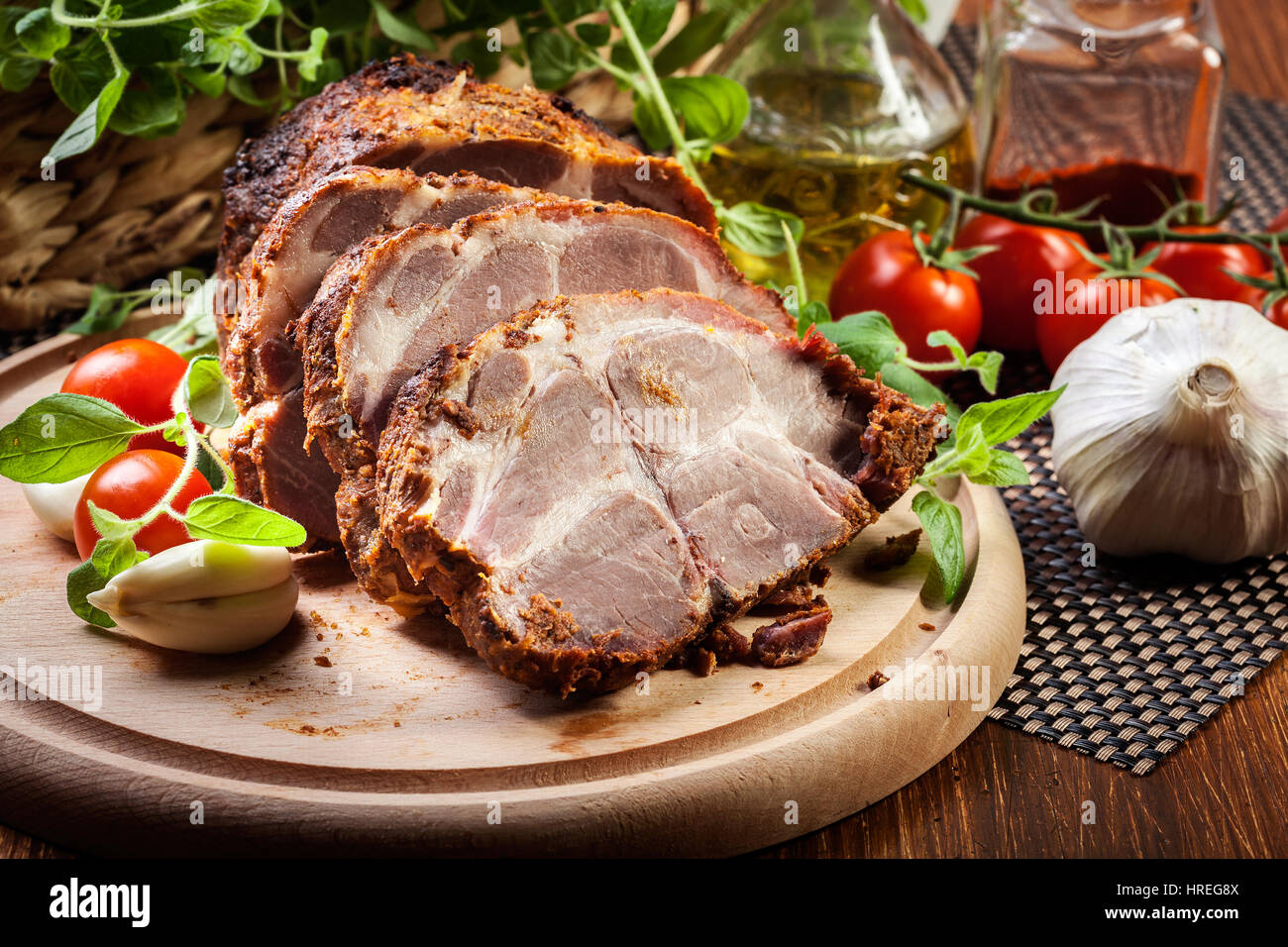 Roasted pork neck with spices on cutting board Stock Photo - Alamy