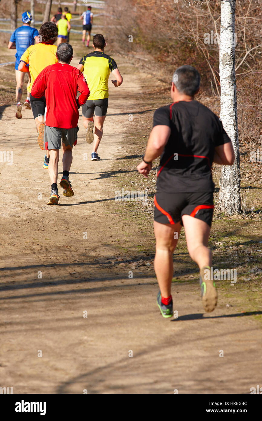 Men athletics runners on a race. Outdoor circuit. Vertical Stock Photo ...