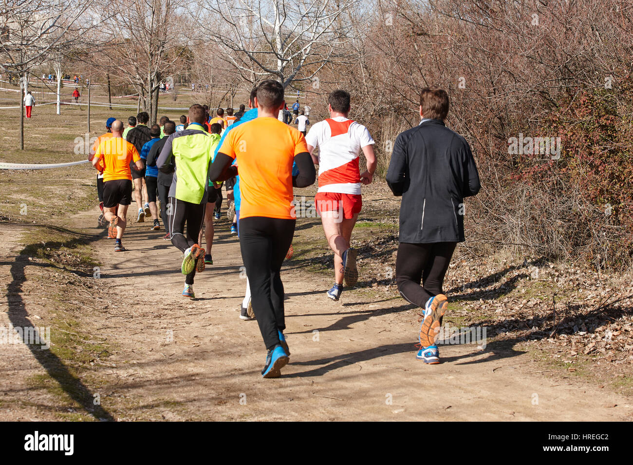 Men athletics runners on a countryside race. Outdoor circuit ...