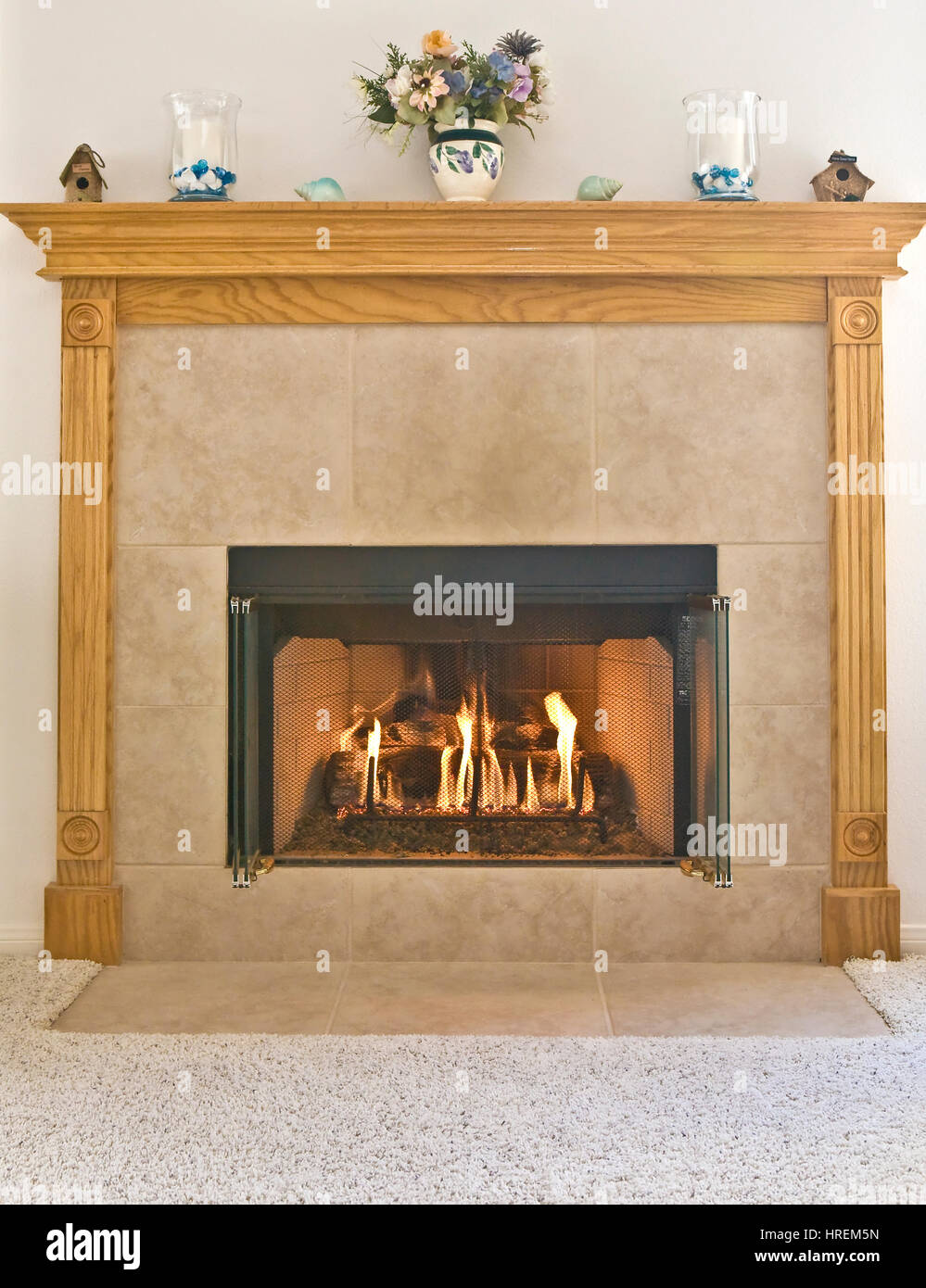 fire in fireplace with mantle decorations Stock Photo - Alamy