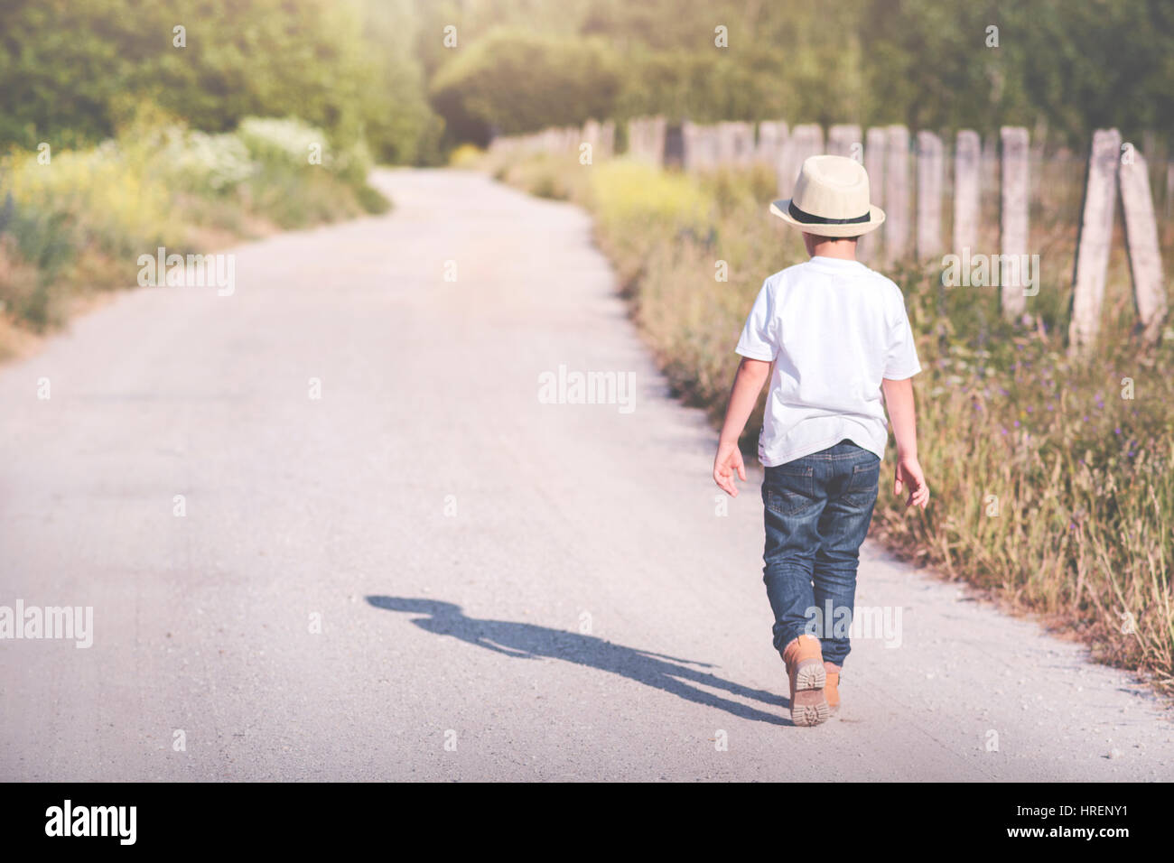 Boy walking along the road Stock Photo - Alamy