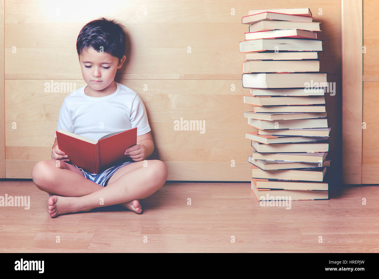 Boy reading a book Stock Photo - Alamy