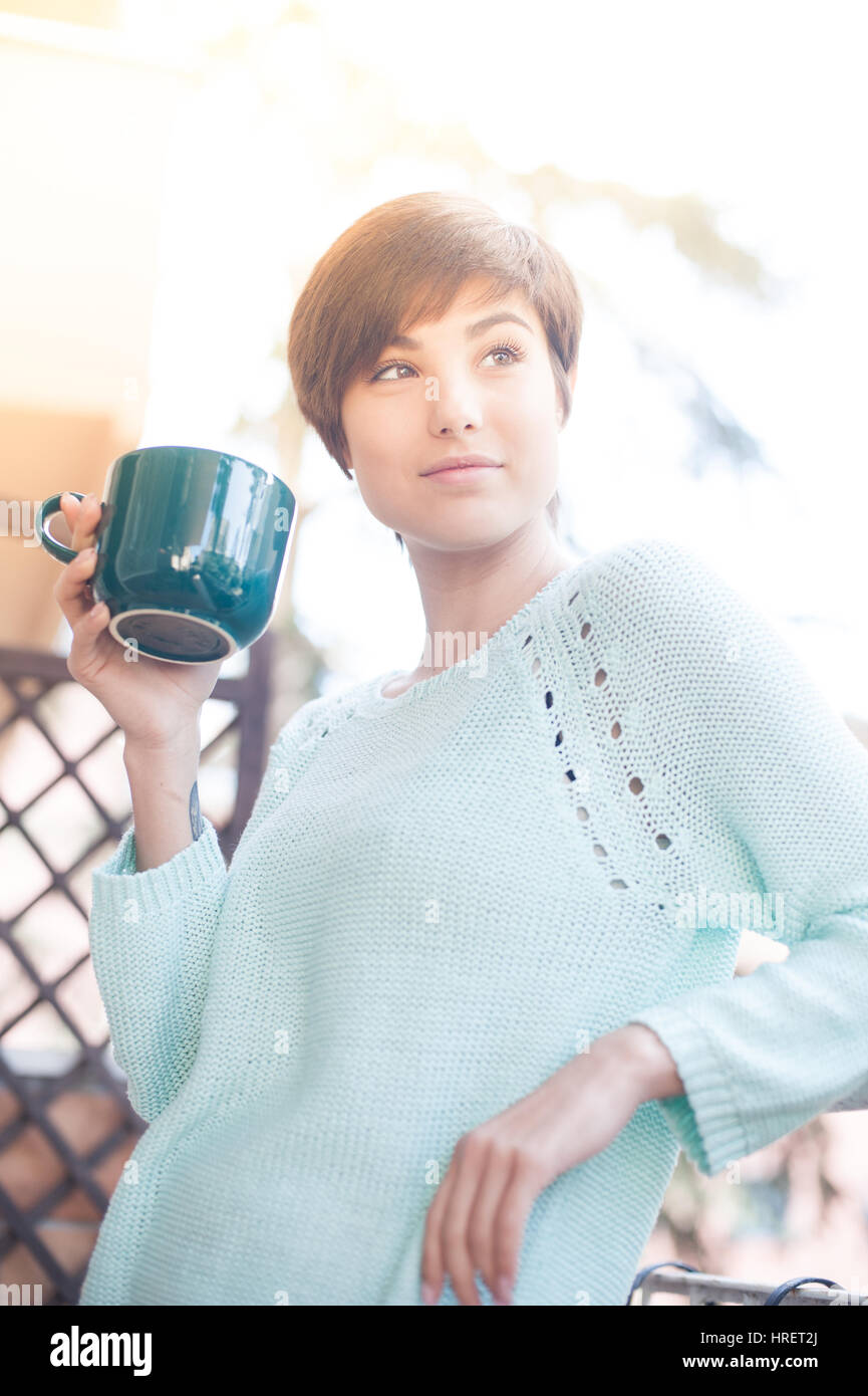 Young pretty woman relaxing with big blue mug and looking out Stock ...