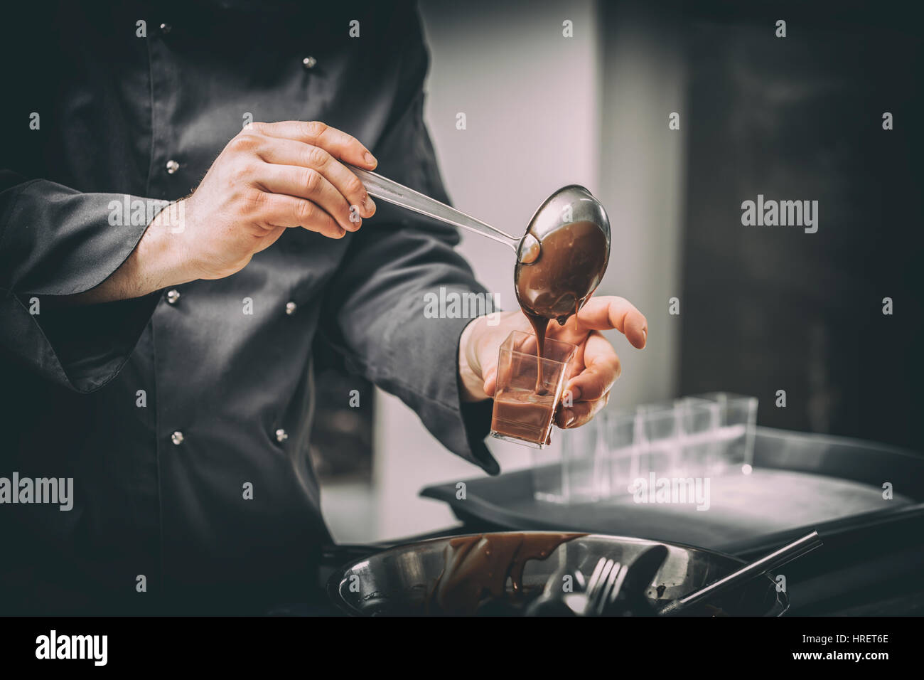 Chef preparing chocolate mousse dessert in restaurant kitchen Stock ...
