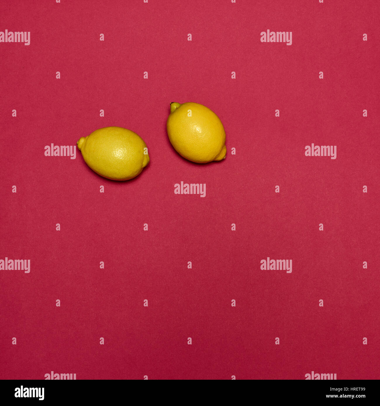 The fresh lemons on the red background Stock Photo - Alamy