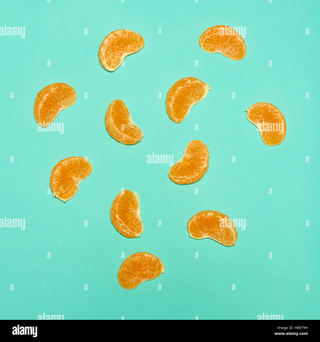 Ripe Mandarin fruits peeled open on the blue background Stock Photo - Alamy