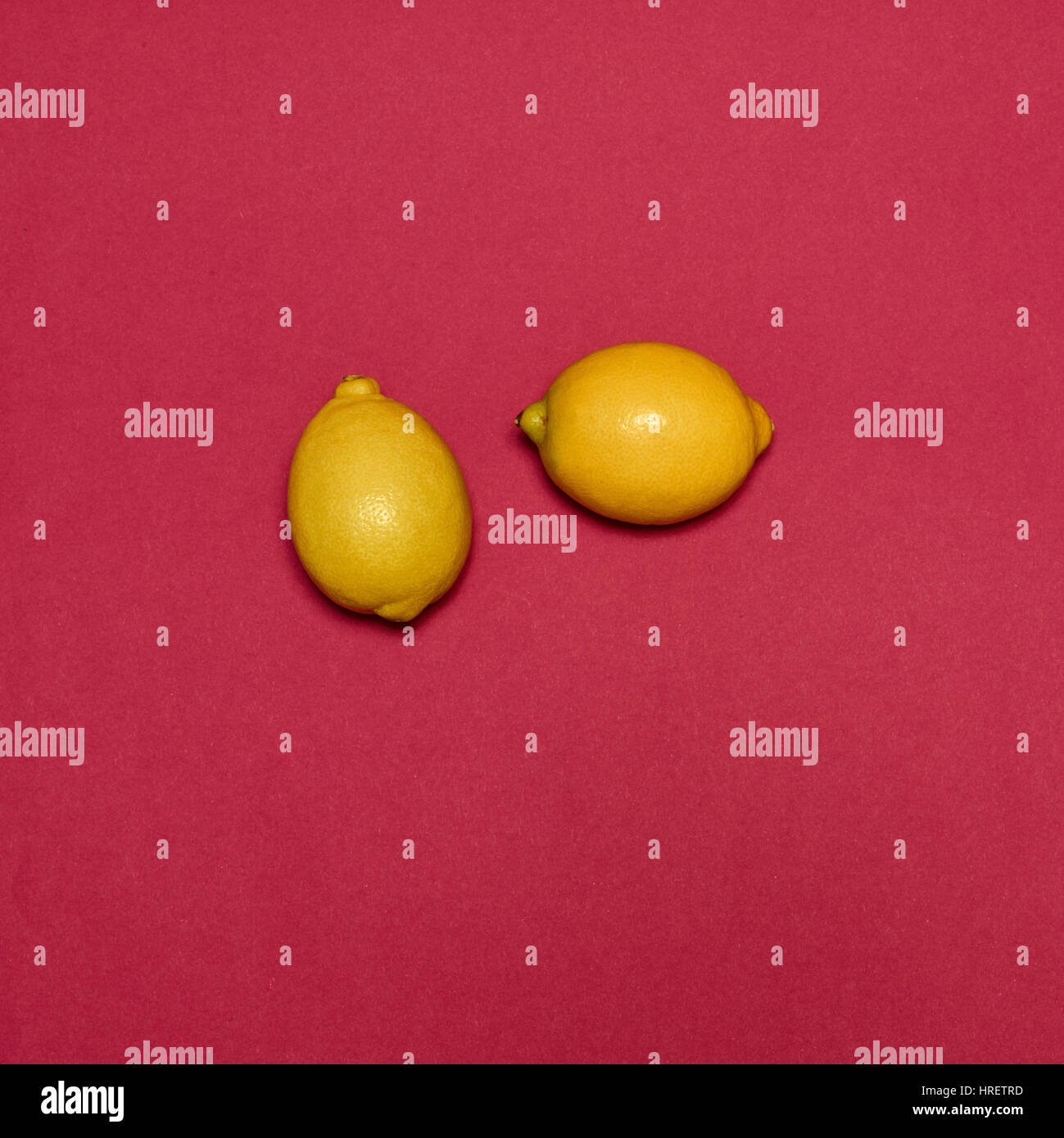 The fresh lemons on the red background Stock Photo - Alamy