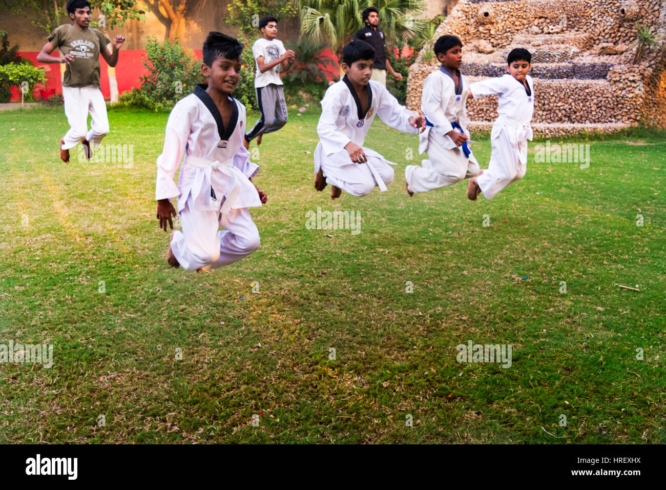 kids jumping during karate class at a public park of pakistan Stock ...