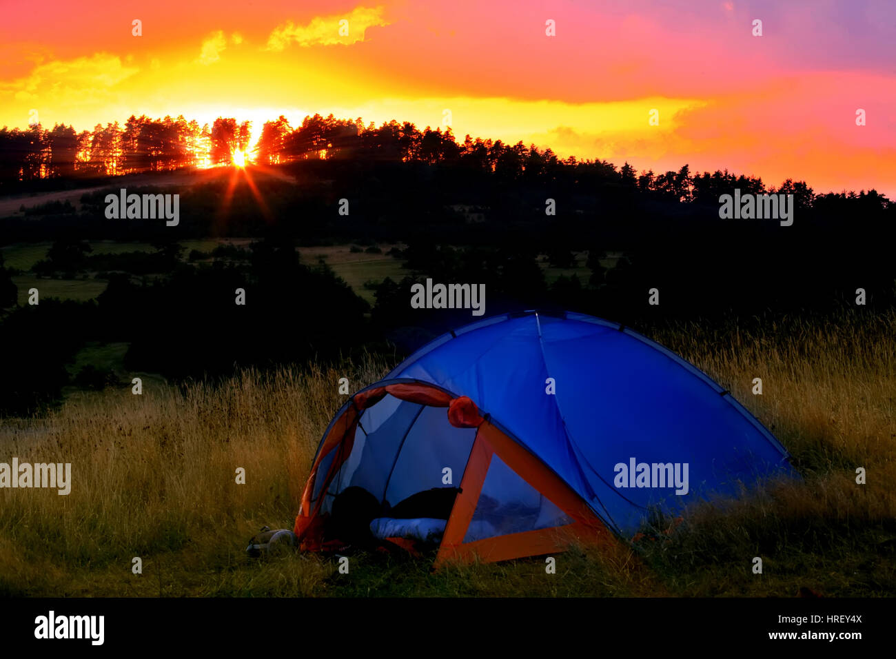 recreation area and camp with tent, sunset time with sun fall over the ...