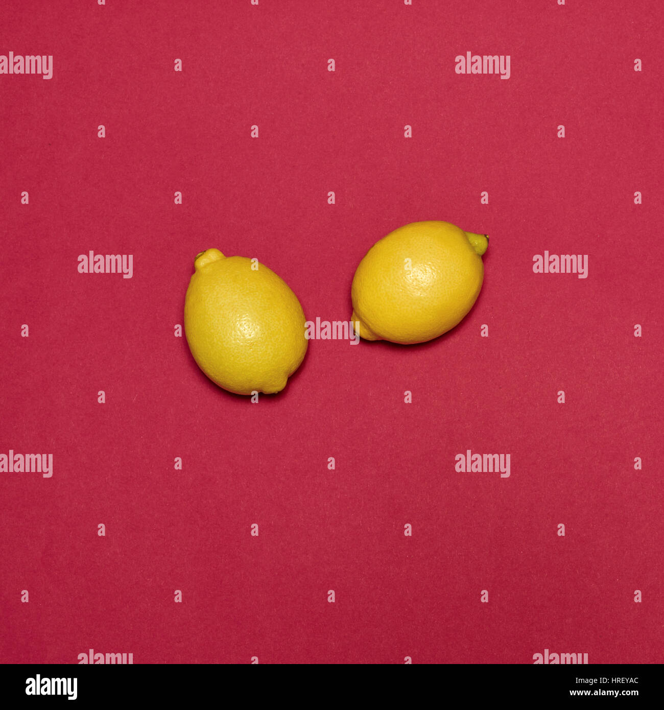 The fresh lemons on the red background Stock Photo - Alamy