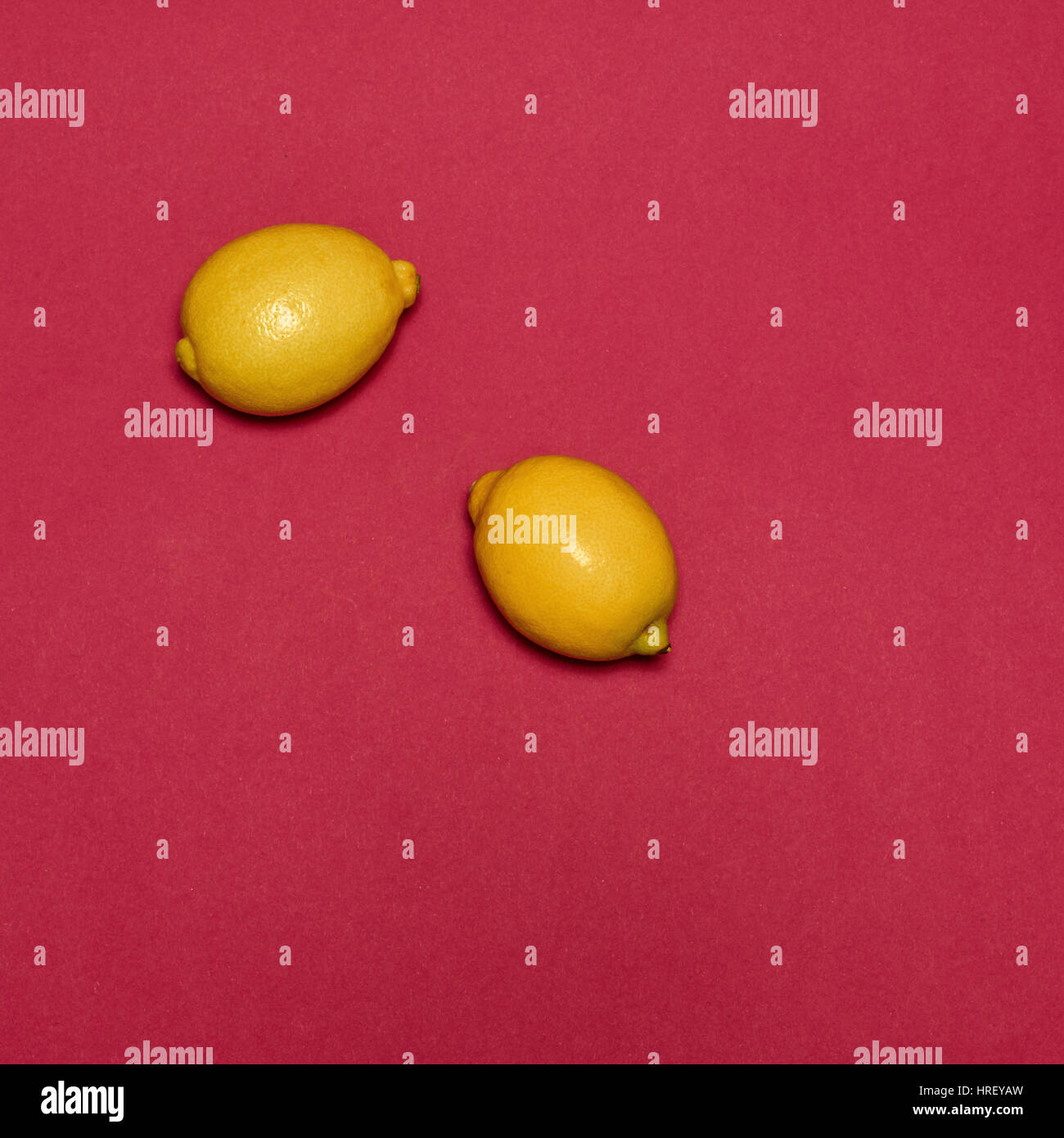 The fresh lemons on the red background Stock Photo - Alamy