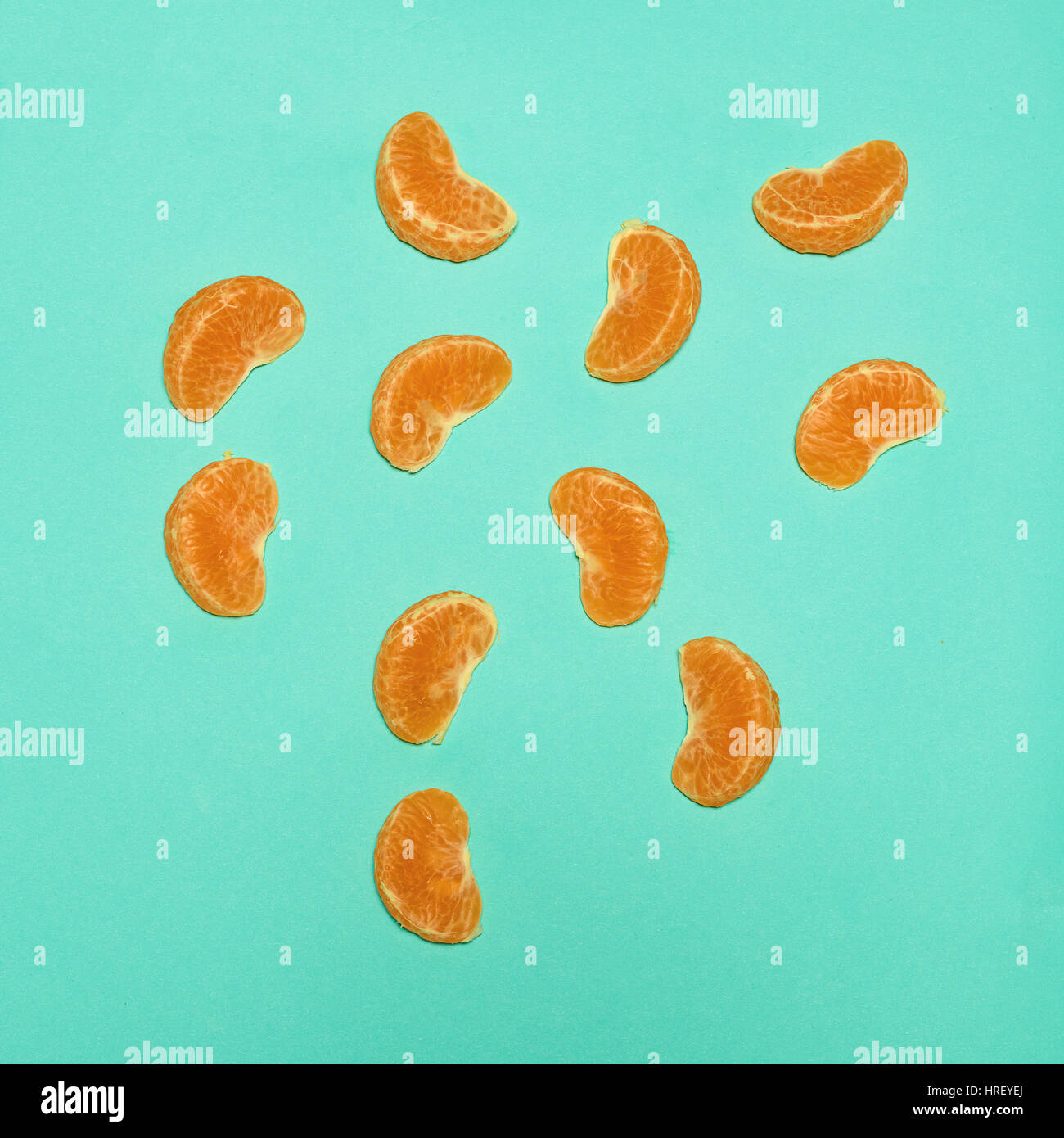 Ripe Mandarin fruits peeled open on the blue background Stock Photo - Alamy
