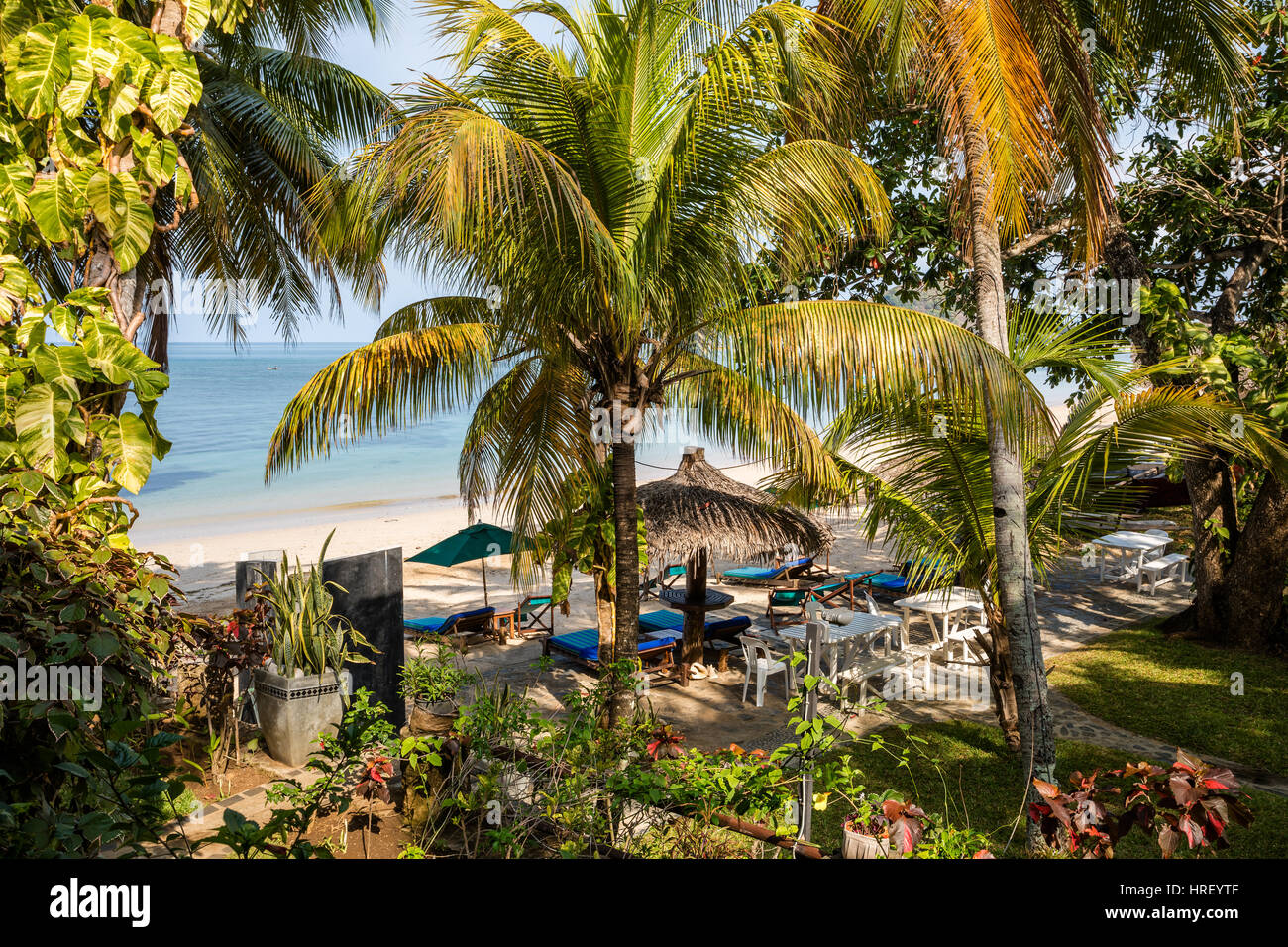 Path way to Nosy Be paradise beach with parasols and sunloungers, in ...