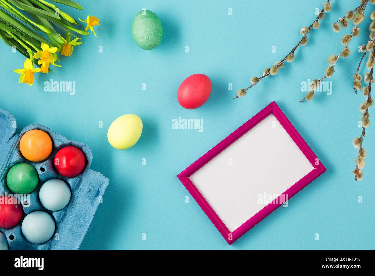 Easter in the office workplace on blue table. Top view with copy space ...