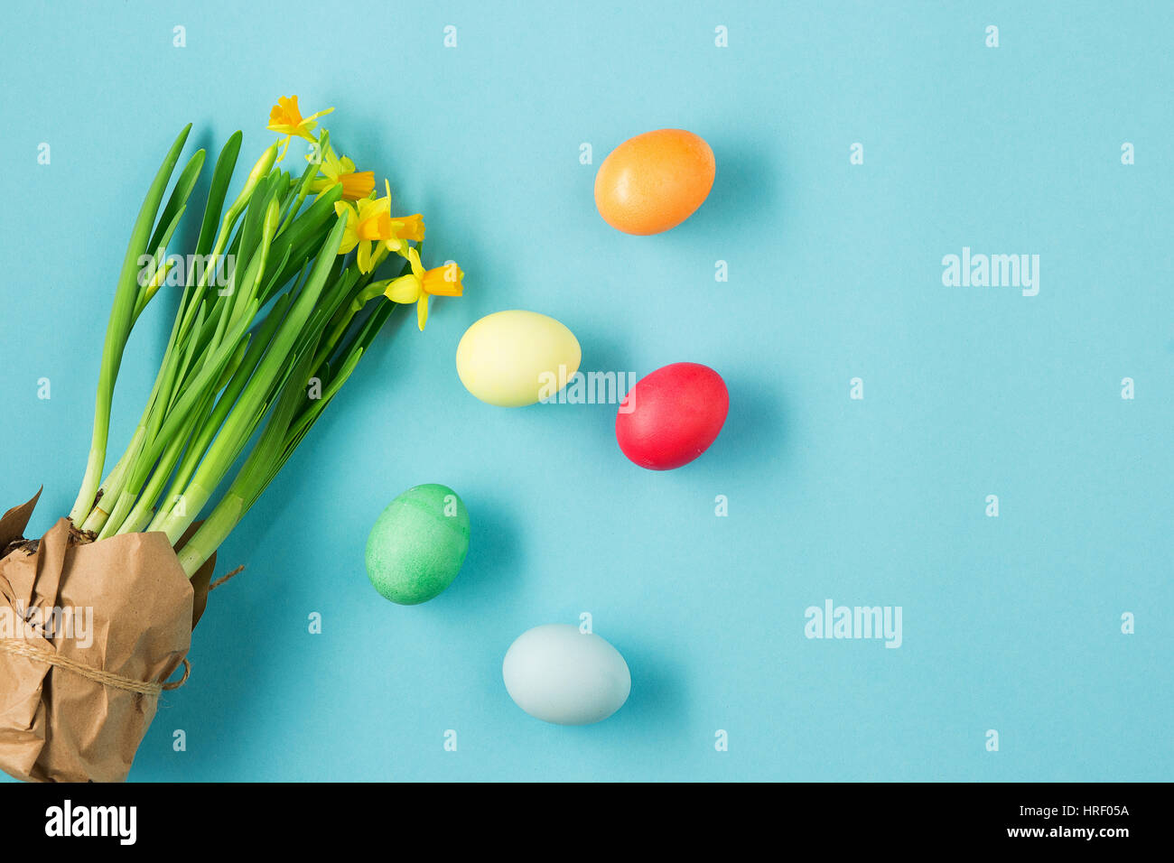 Easter in the office workplace on blue table. Top view with copy space ...