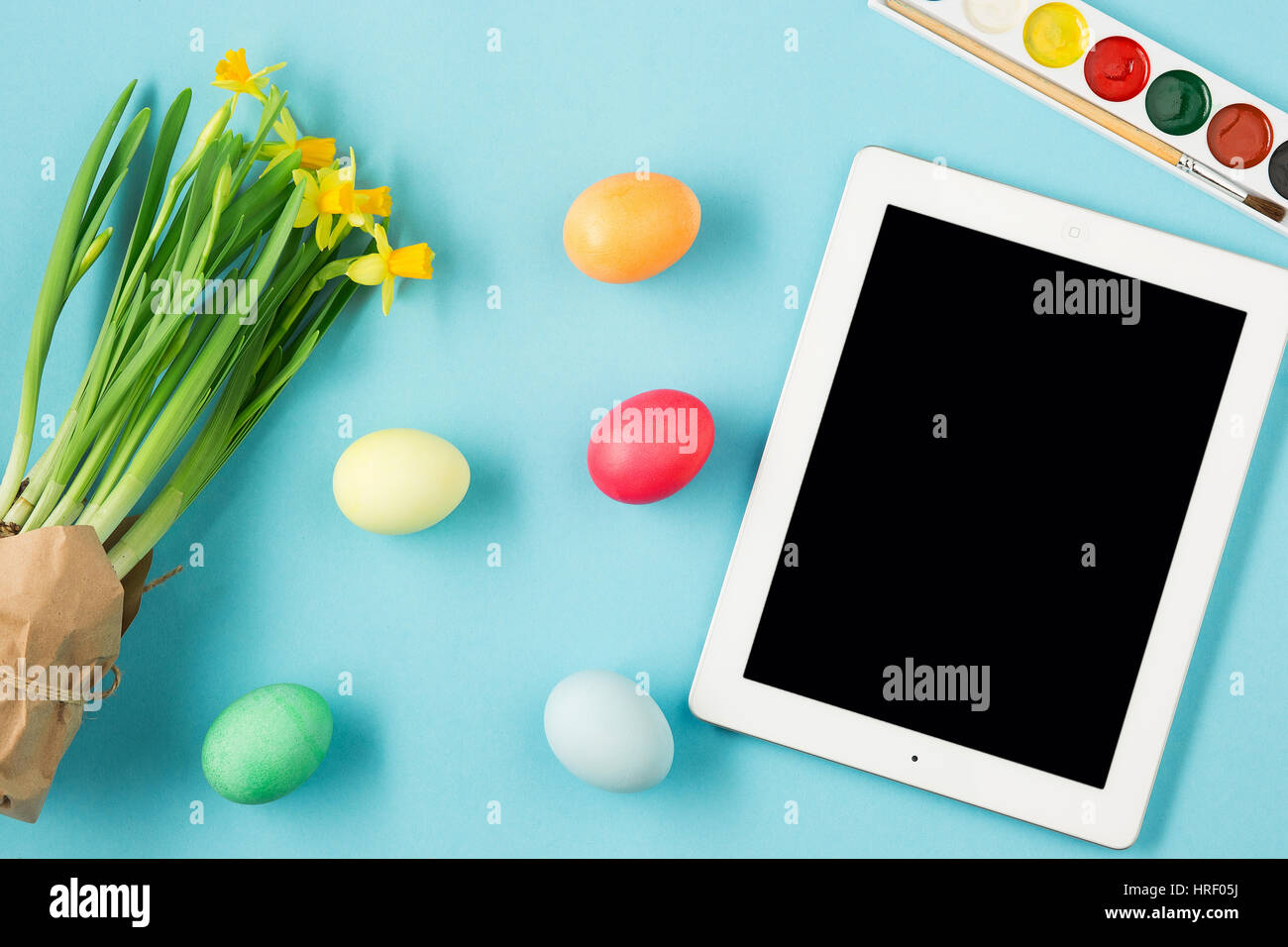 Easter in the office workplace on blue table. Top view with copy space ...