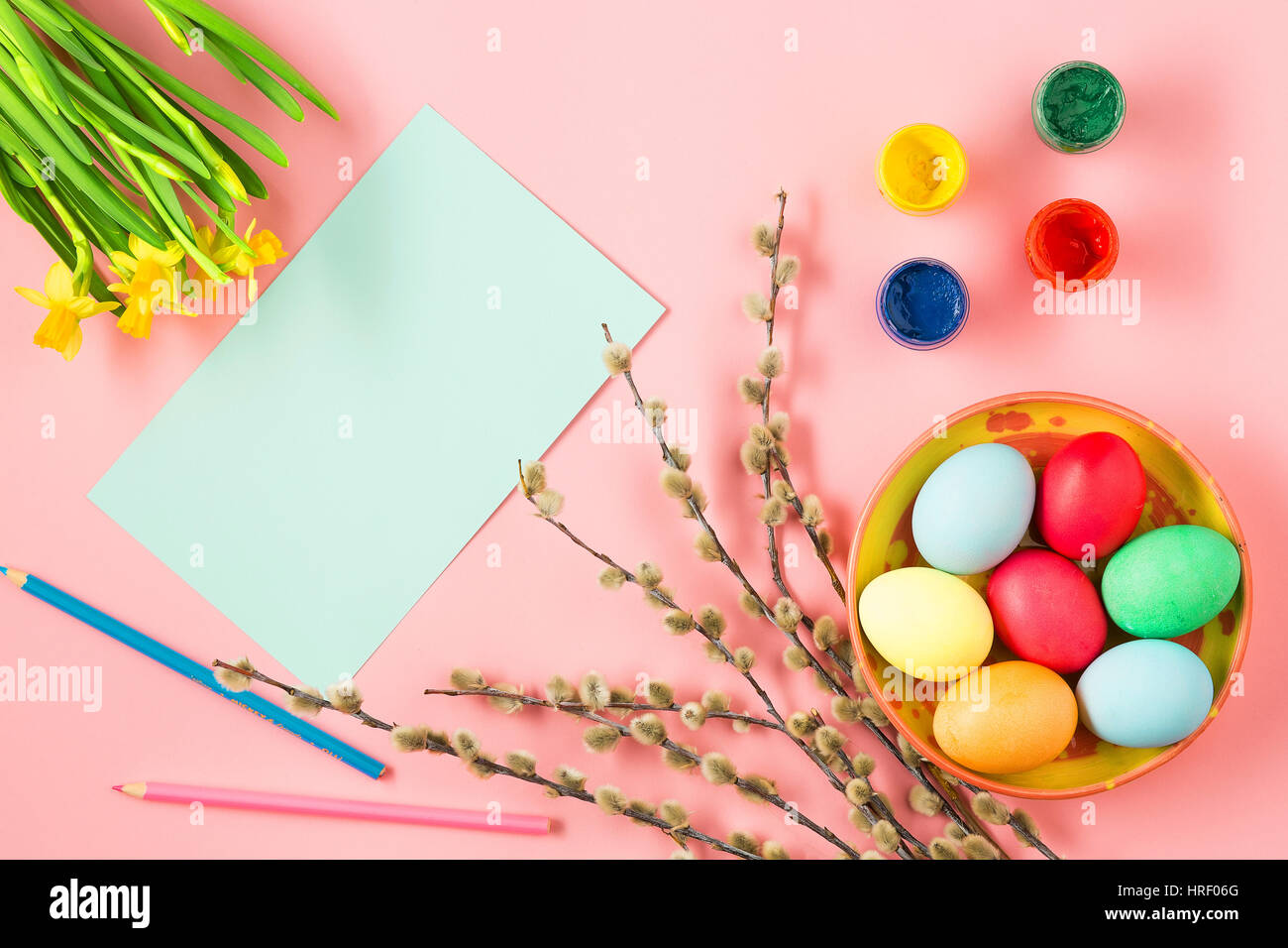 Easter in the office workplace on pink table. Top view with copy space ...