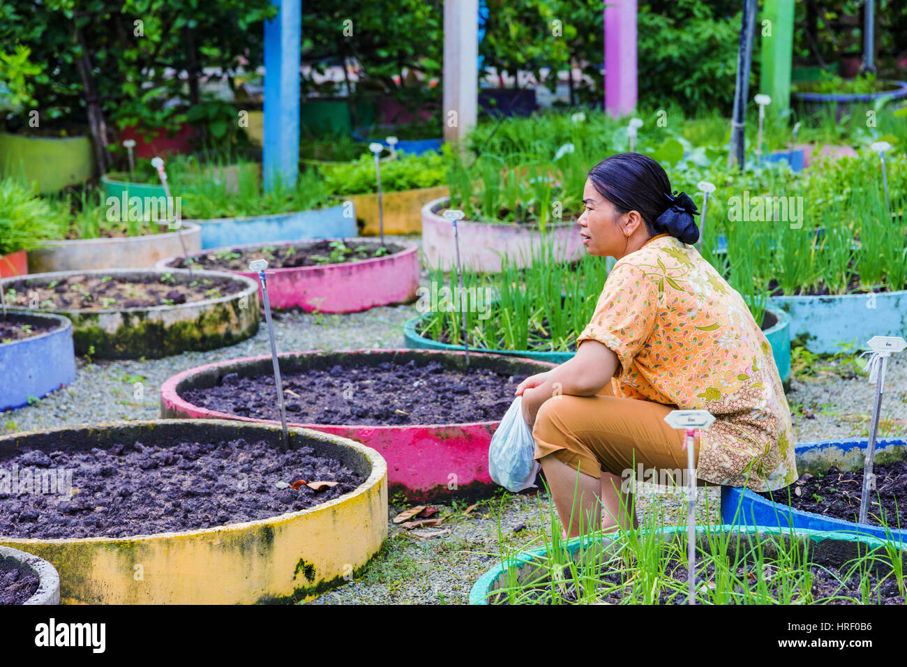 PATTAYA, THAILAND Thai farm working taking a rest and sitting down ...