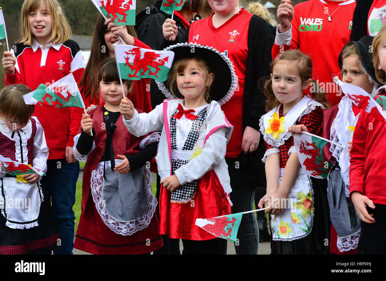 School children in traditional Welsh outfits waves flags as they wait ...