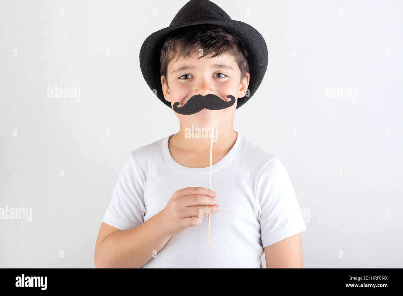little boy playing with mustache Stock Photo - Alamy