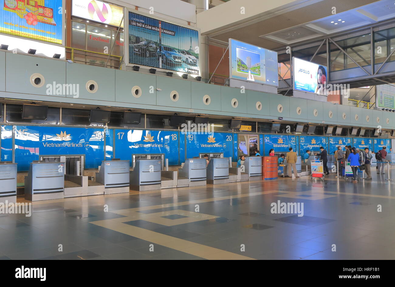 People check in at Vietnam Airline counter Hanoi International airport ...