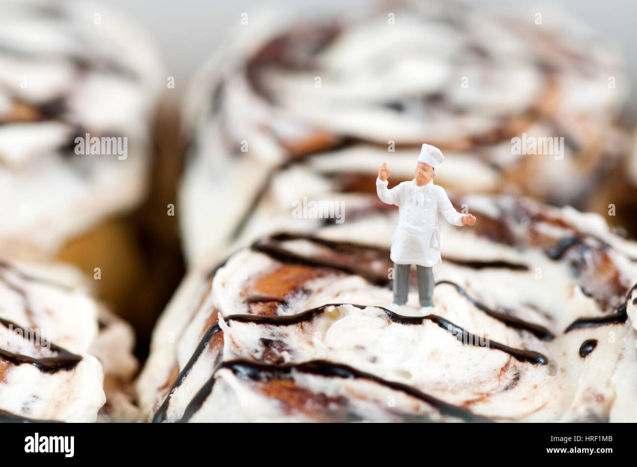 Miniature Chef on top of the Cinnamon roll Stock Photo - Alamy