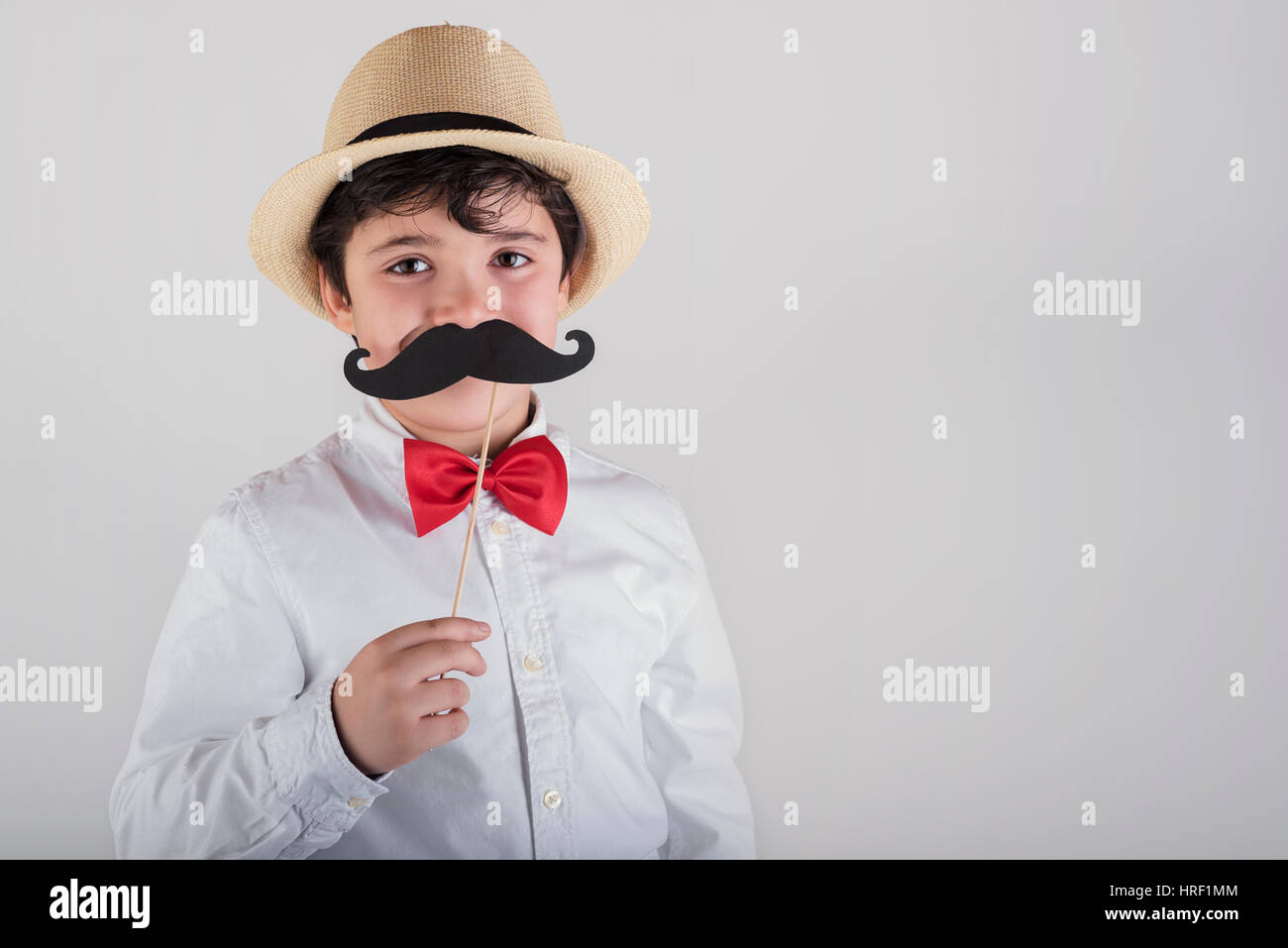 little boy playing with mustache Stock Photo - Alamy