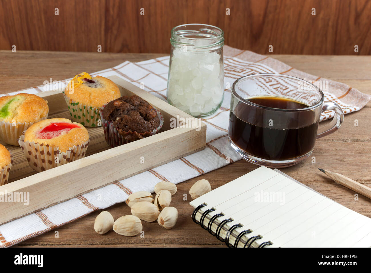 Cupcake various flavors in wood tray on wood table. coffee break with ...