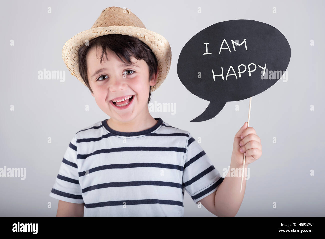 happy child. Portrait of happy boy holding sign Stock Photo - Alamy