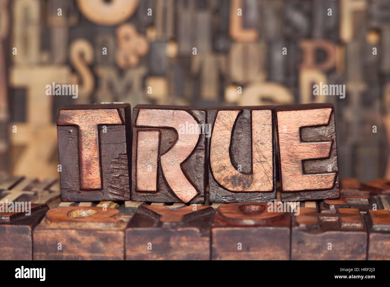 TRUE word made from wooden letterpress blocks on many different letters ...
