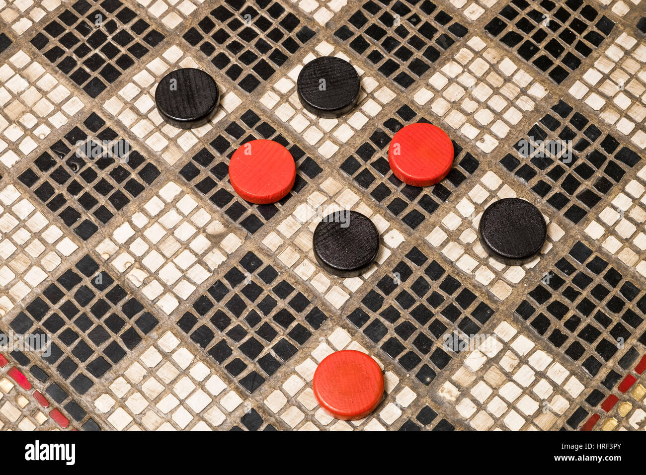 Red and black checkers on a black and white checker board made with ...