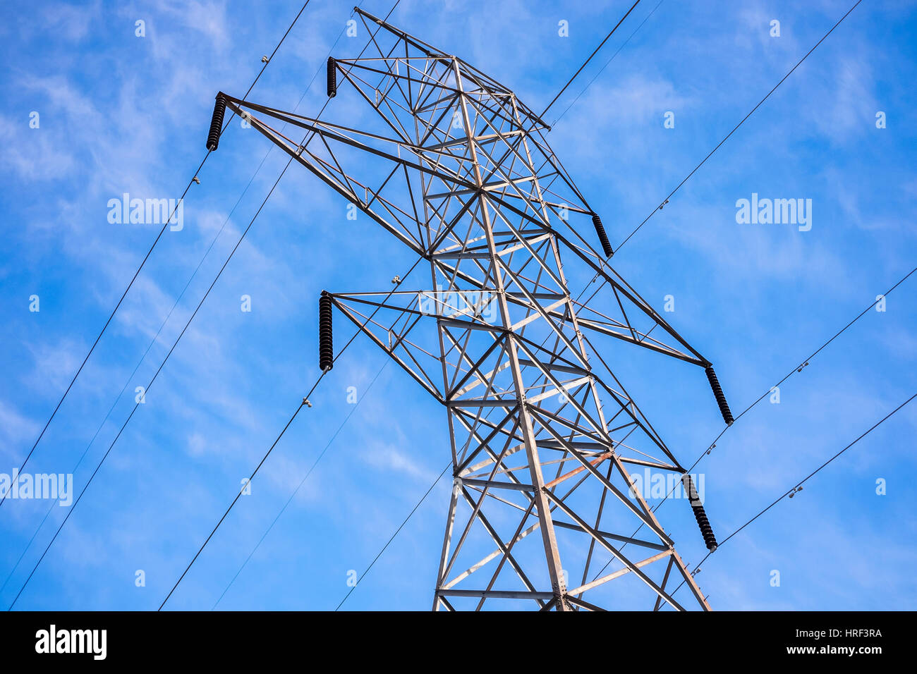 Looking up at a steel hydro tower with insulators holding high voltage ...