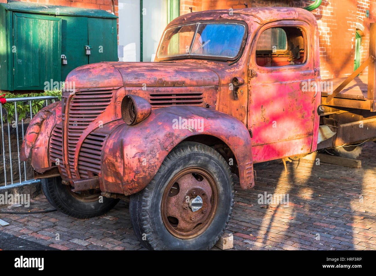 An old rusty red truck partially lit by the evening sun Stock Photo - Alamy