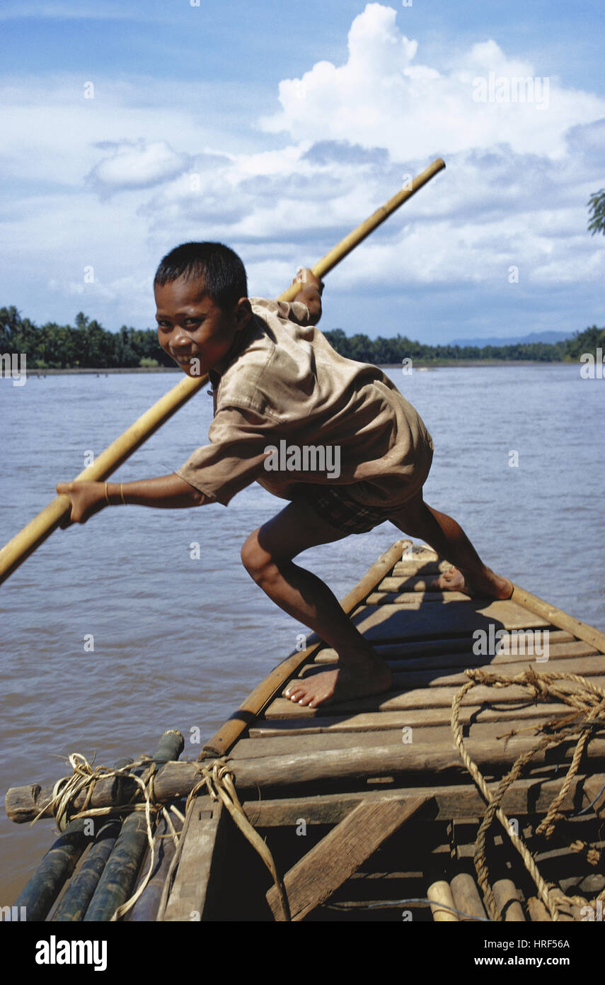 Boy and Boat, Indonesia Stock Photo - Alamy