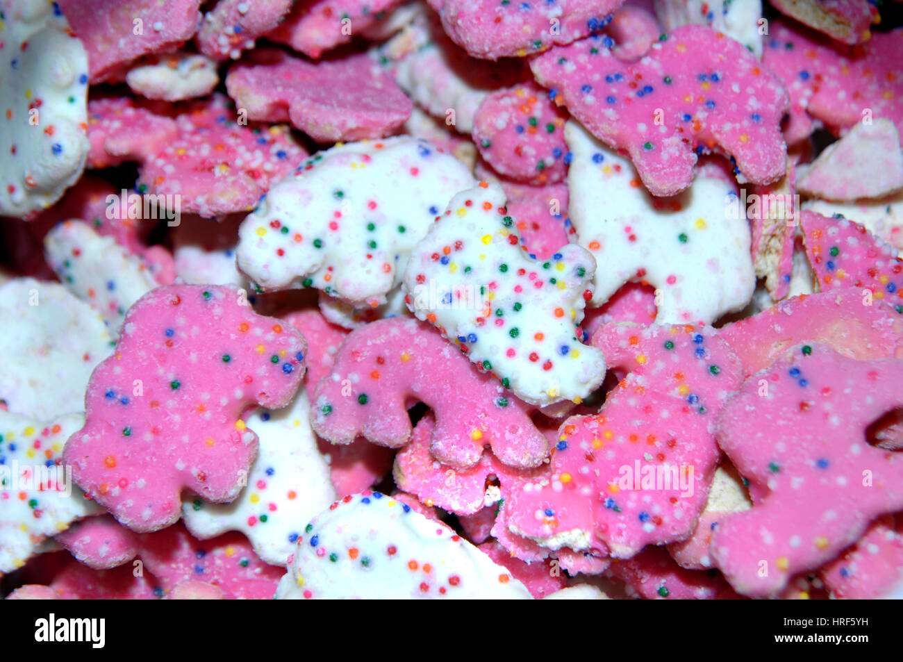 Pile of shaped cookies lie in a pile. Iced cookies are covered in a ...