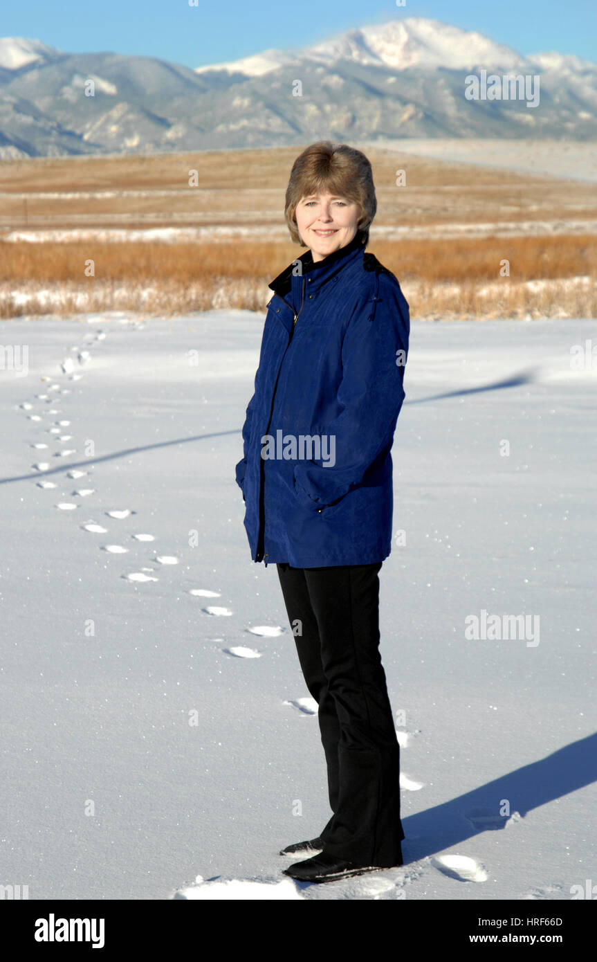 Woman follows trail of footsteps that are leading toward Pike's Peak in ...