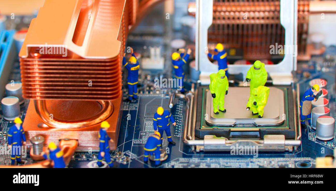 Team of construction workers repairing computer Stock Photo - Alamy