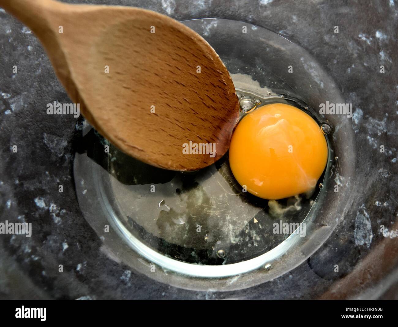 Raw egg in a mixing dish Stock Photo - Alamy