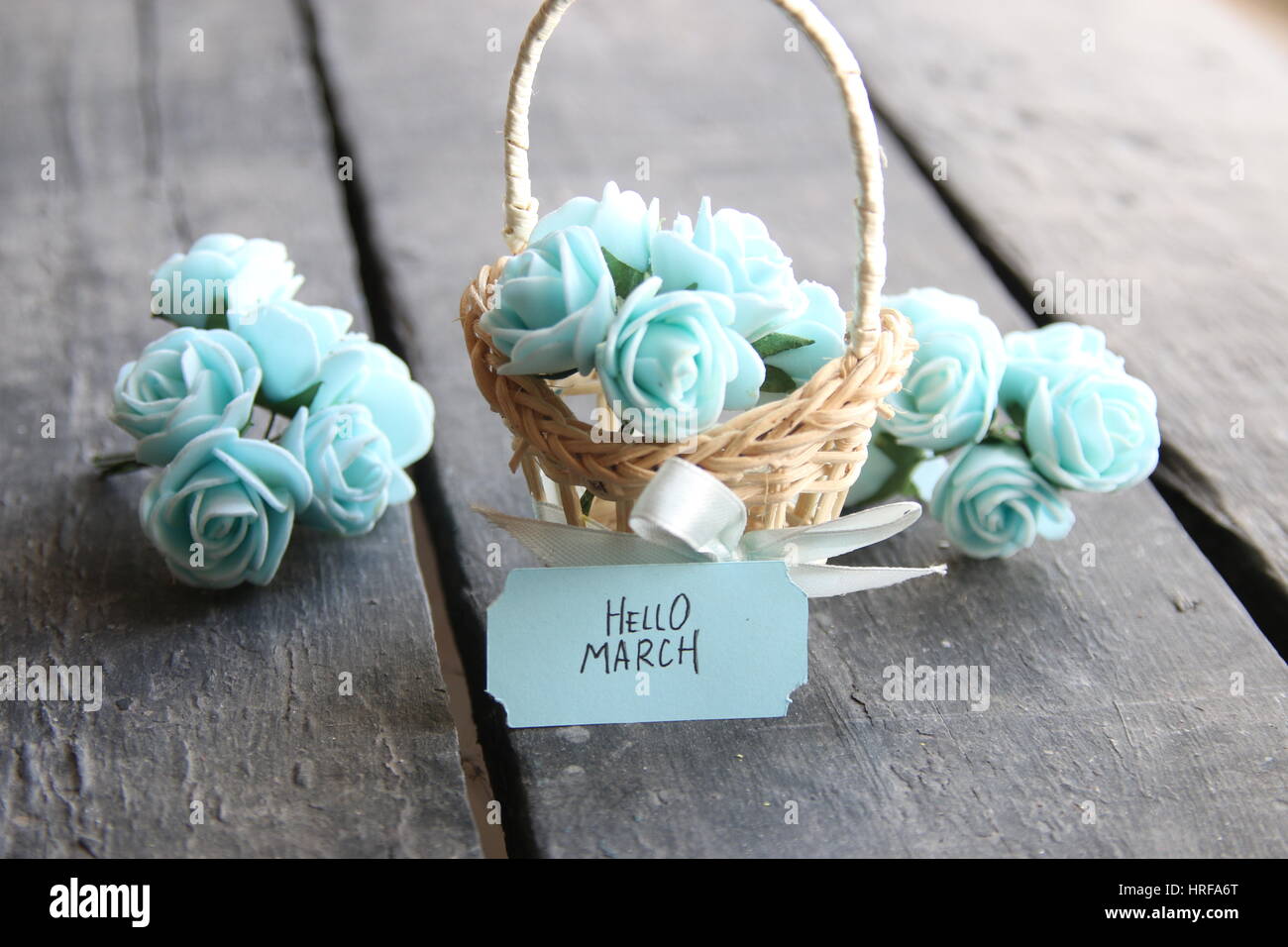 Hello March. Label and beautiful basket of roses on vintage table Stock ...