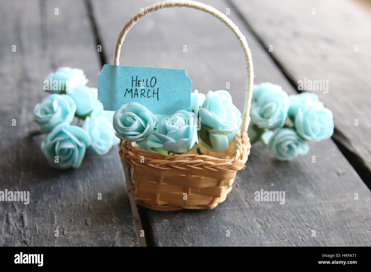 Hello March. Label and beautiful basket of roses on vintage table Stock ...