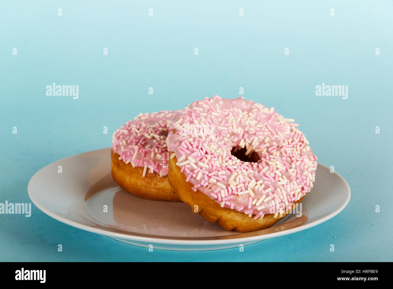 Iced doughnut on a light coloured blue background Stock Photo - Alamy