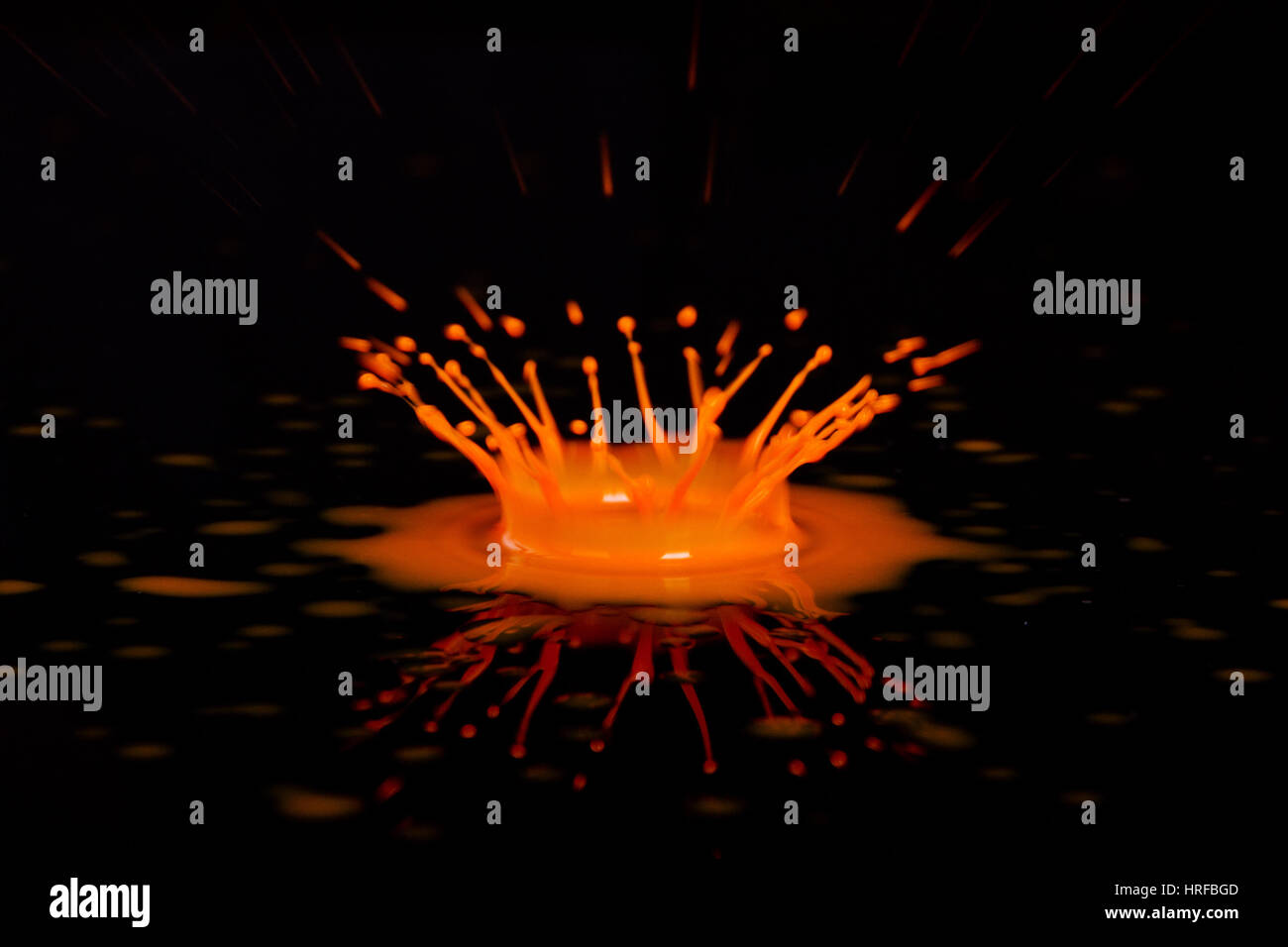 Colorful paint drop splashing on black a background Stock Photo - Alamy