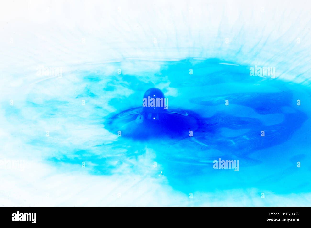 Colorful paint drop splashing on black a background Stock Photo - Alamy