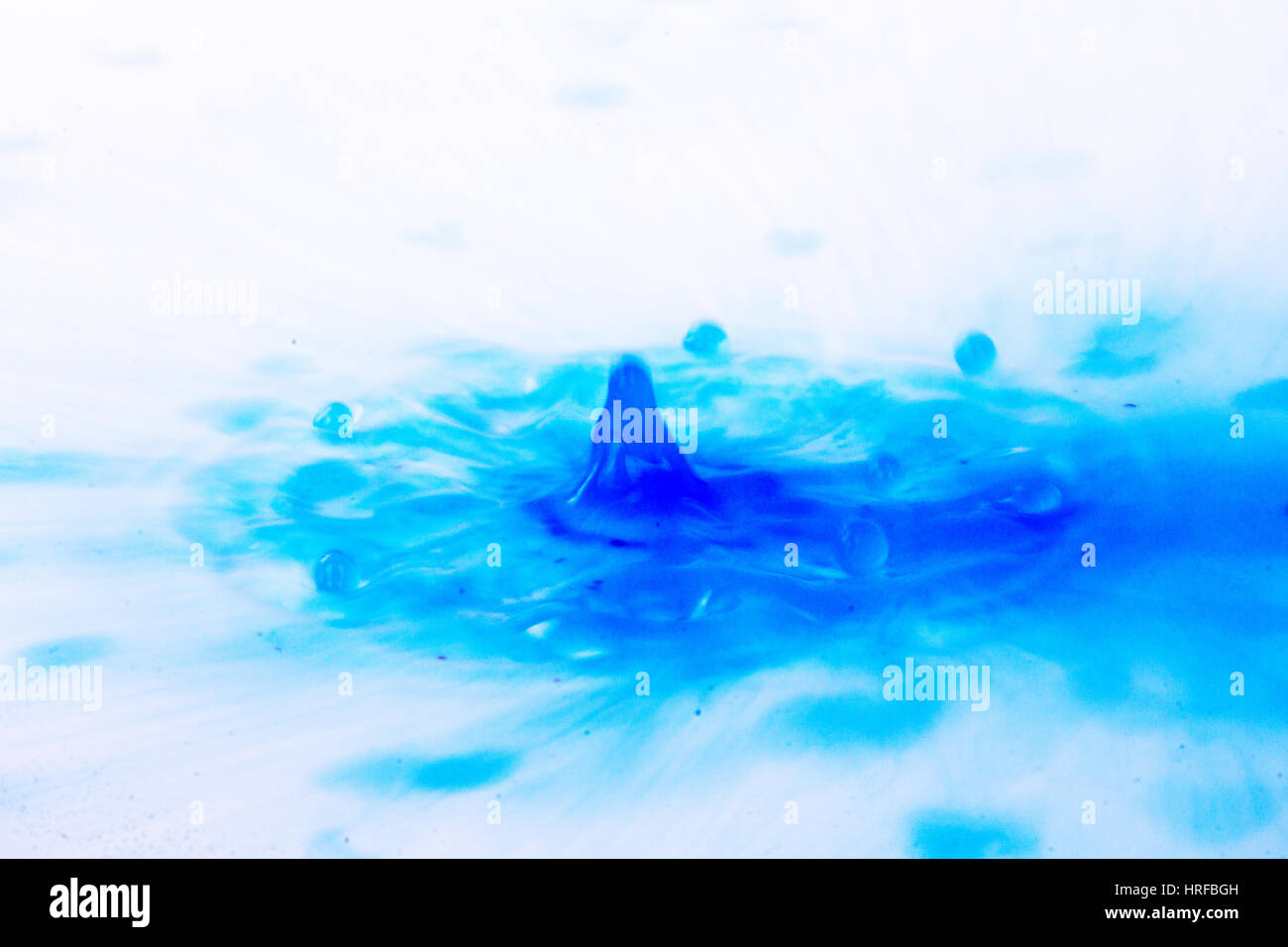 Colorful paint drop splashing on black a background Stock Photo - Alamy